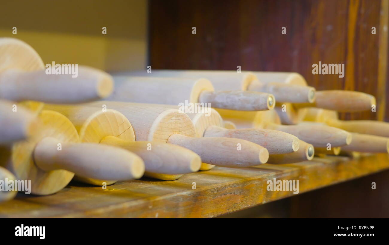 The edge of the rolling pins on the shelf inside the kitchen where they ...