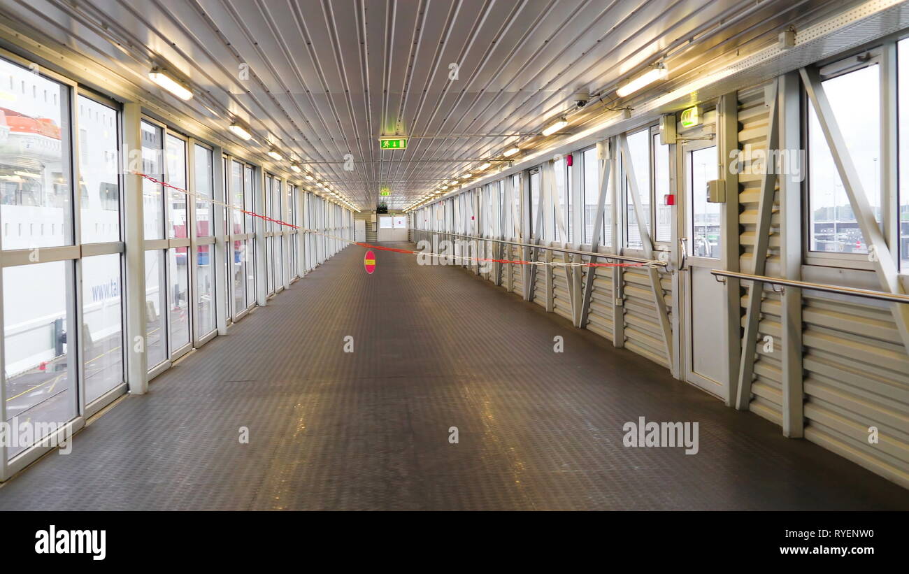 Inside the loading ramp of the ship in the port with the red rope with ...