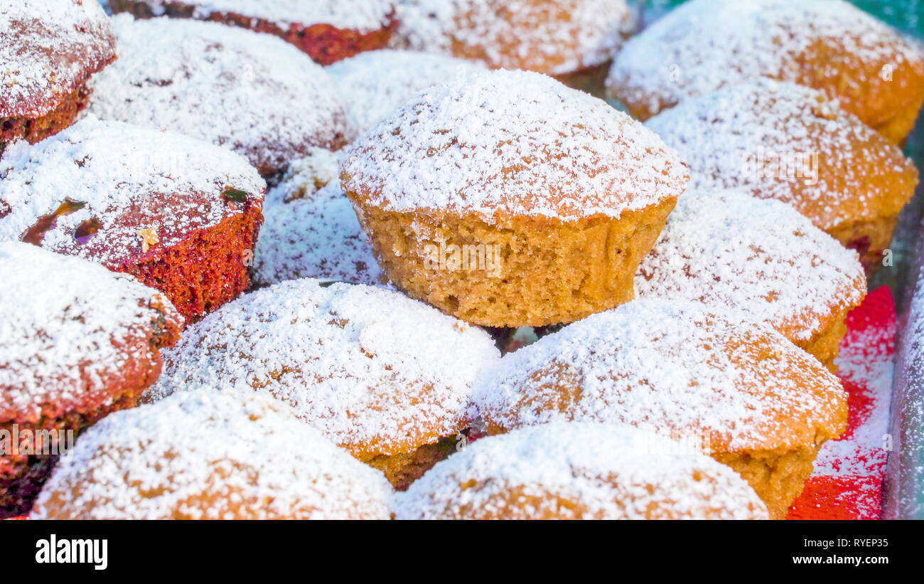 Brown muffins with sugars on top being displayed from the food market ...
