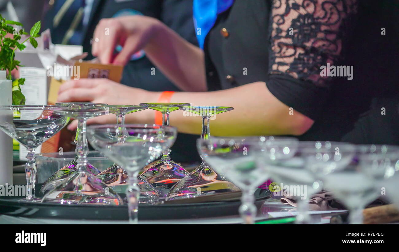 The hands of the barman while preparing their entries during a cocktail ...