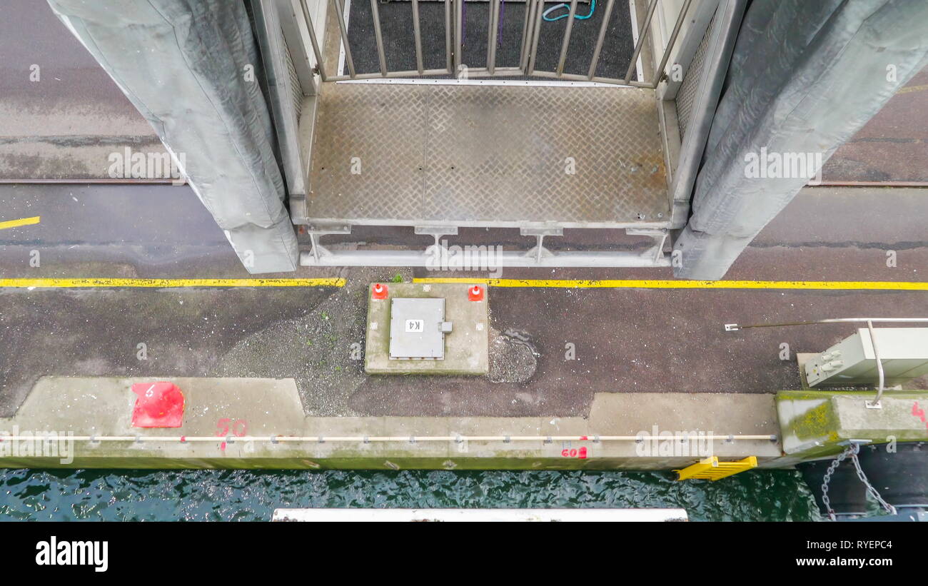 The passenger ramp loader being detached on the ship about to depart ...