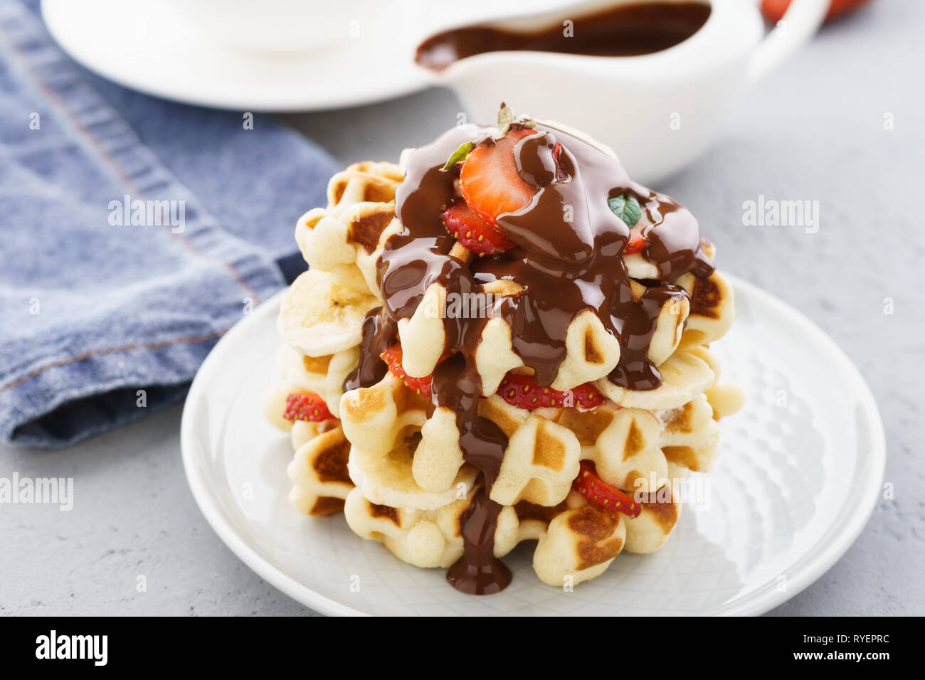 Belgium waffles with strawberries, banana and flowing chocolate for ...