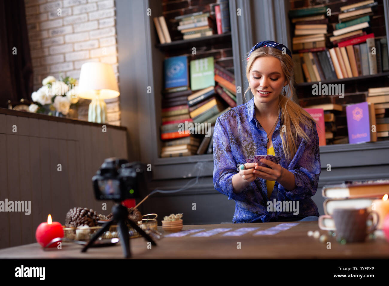 Positive joyful young woman reading tarot cards Stock Photo - Alamy