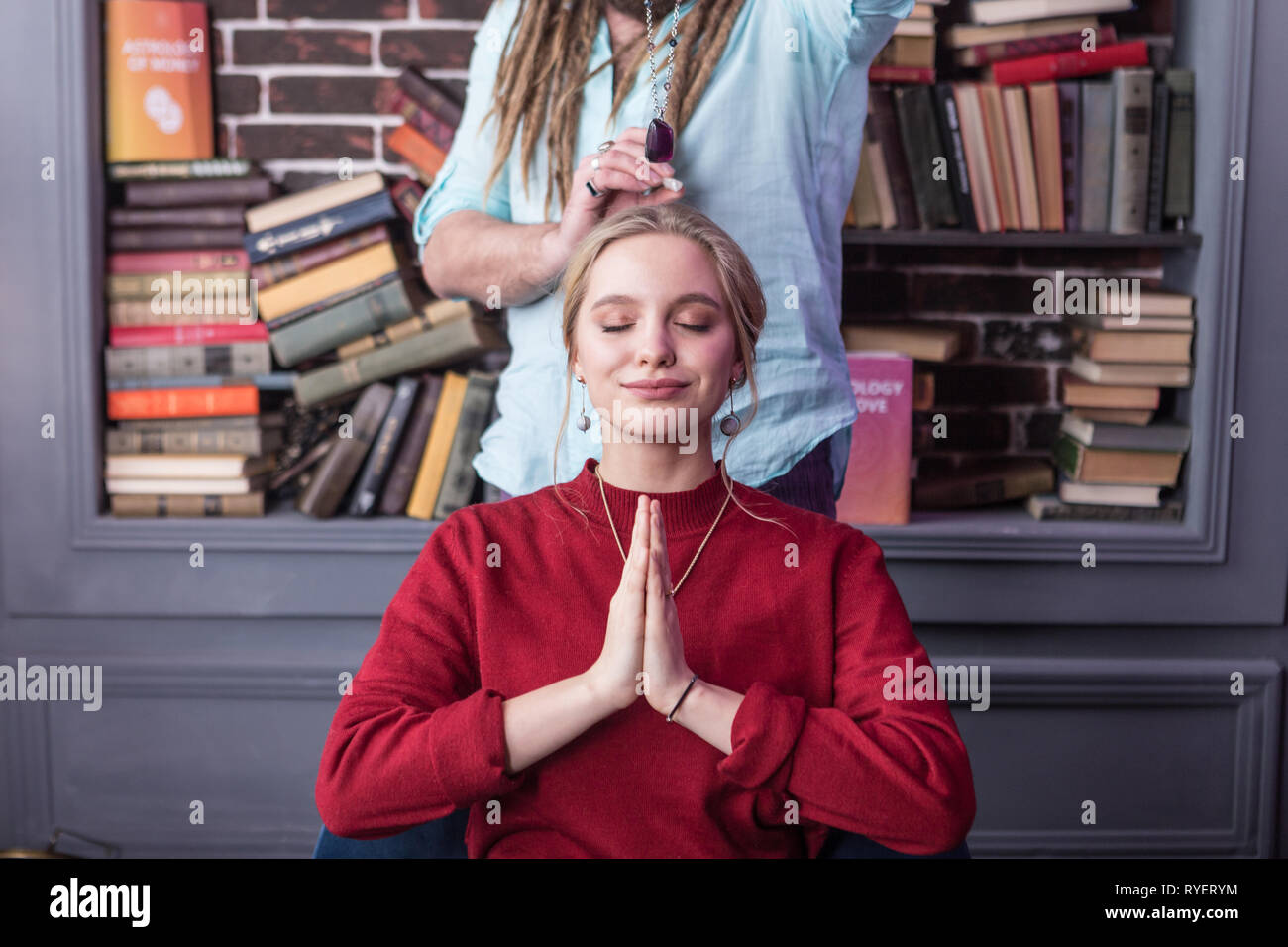 Delighted good looking woman closing her eyes Stock Photo - Alamy