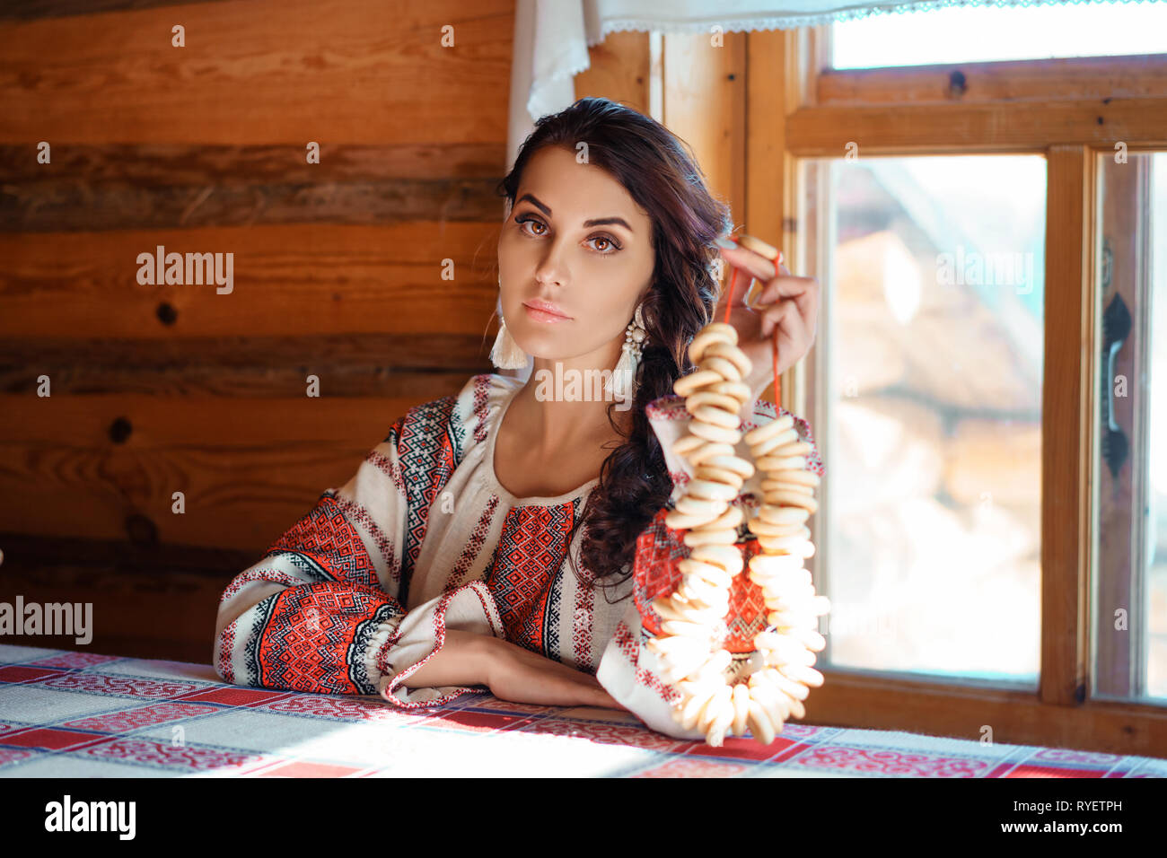 beautiful young woman in national costume sitting in a hut Stock Photo ...