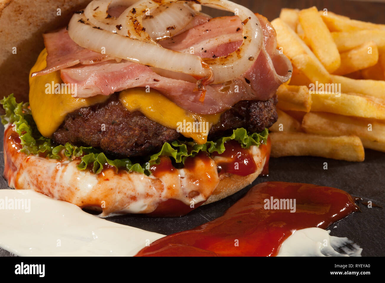 Hamburger with beef meat bacon molten cheese onion rings lettuce french ...