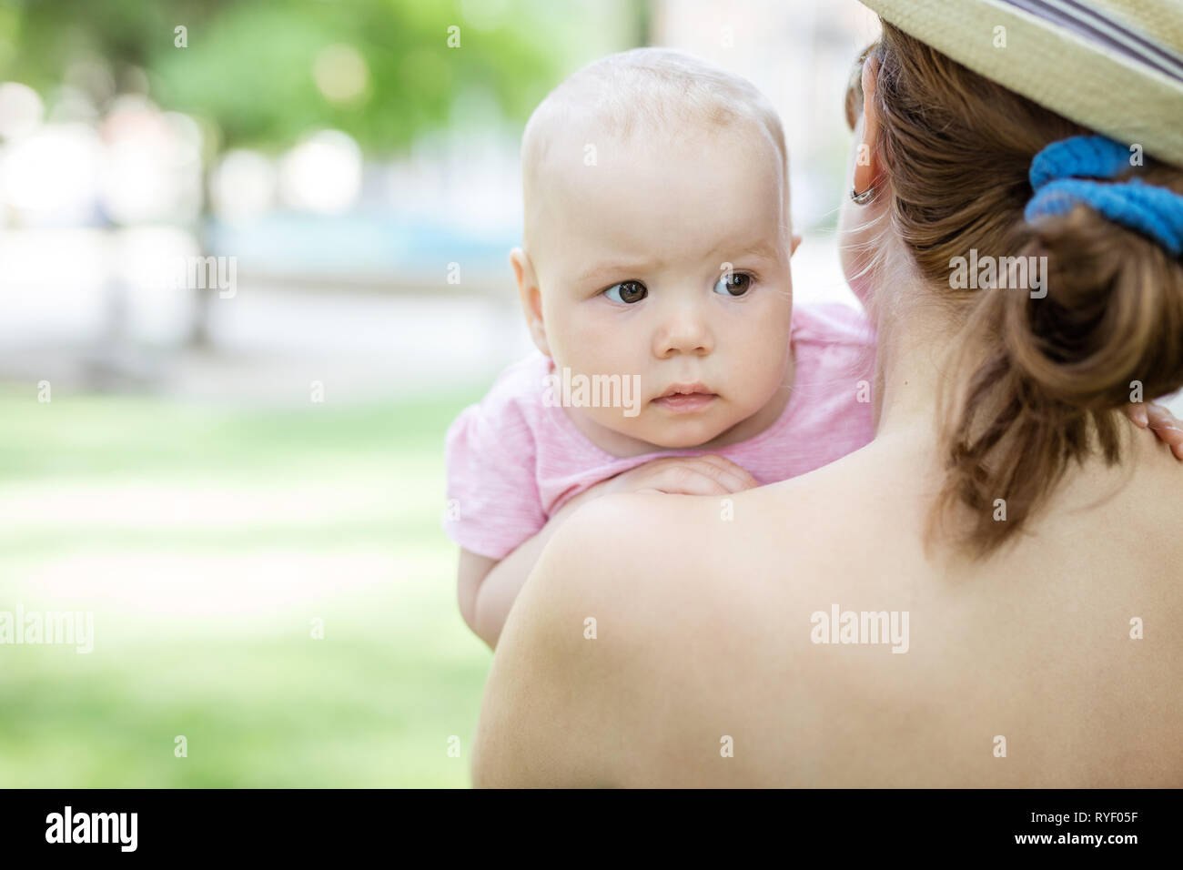 Beautiful baby looking over shoulder hi-res stock photography and ...