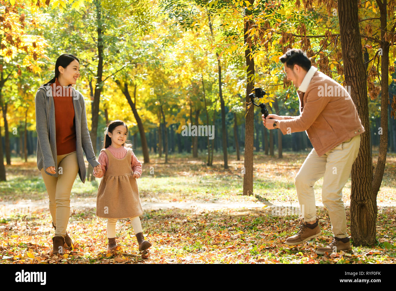 Happy family in the outdoor taking pictures Stock Photo - Alamy