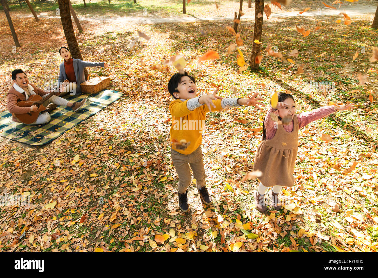 Happy families play outdoors Stock Photo - Alamy