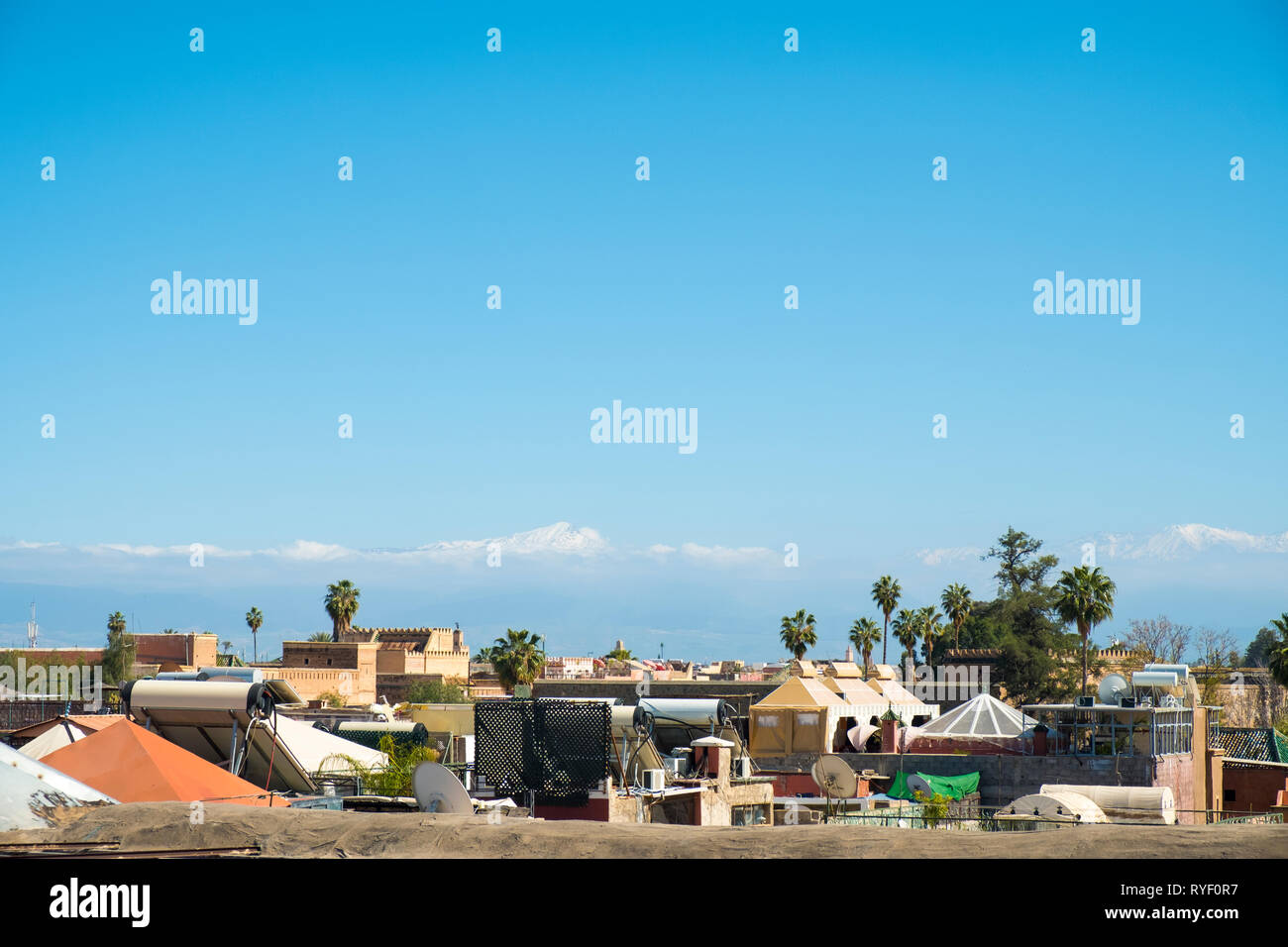 Distant view of snow-capped Atlas Mountains over rooftops in Marrakech ...