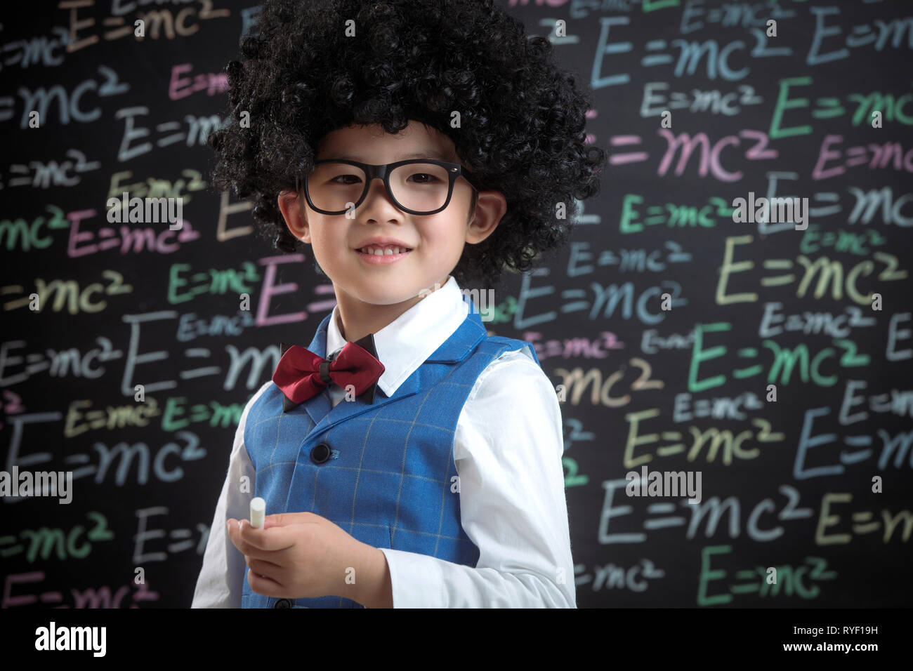 Primary school girl standing in front of the blackboard Stock Photo - Alamy