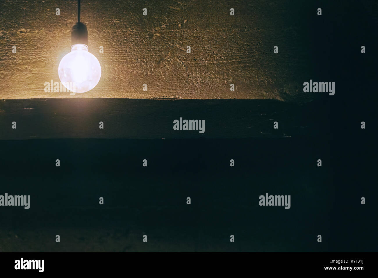 Light bulb against the dark ceiling Stock Photo - Alamy
