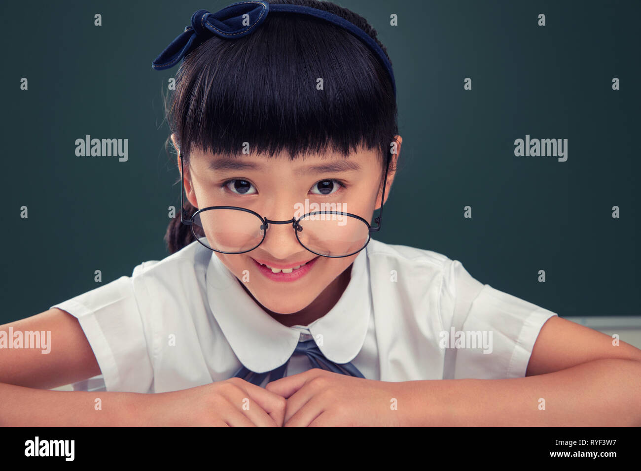 Primary school girl wears glasses Stock Photo - Alamy