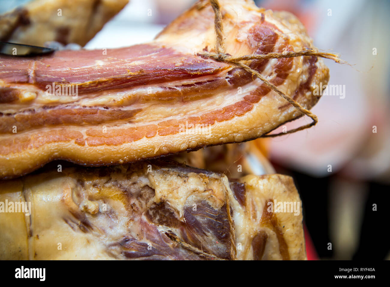 Big pile of whole bacon. Big smoked bacon. Pieces of smoked bacon large ...