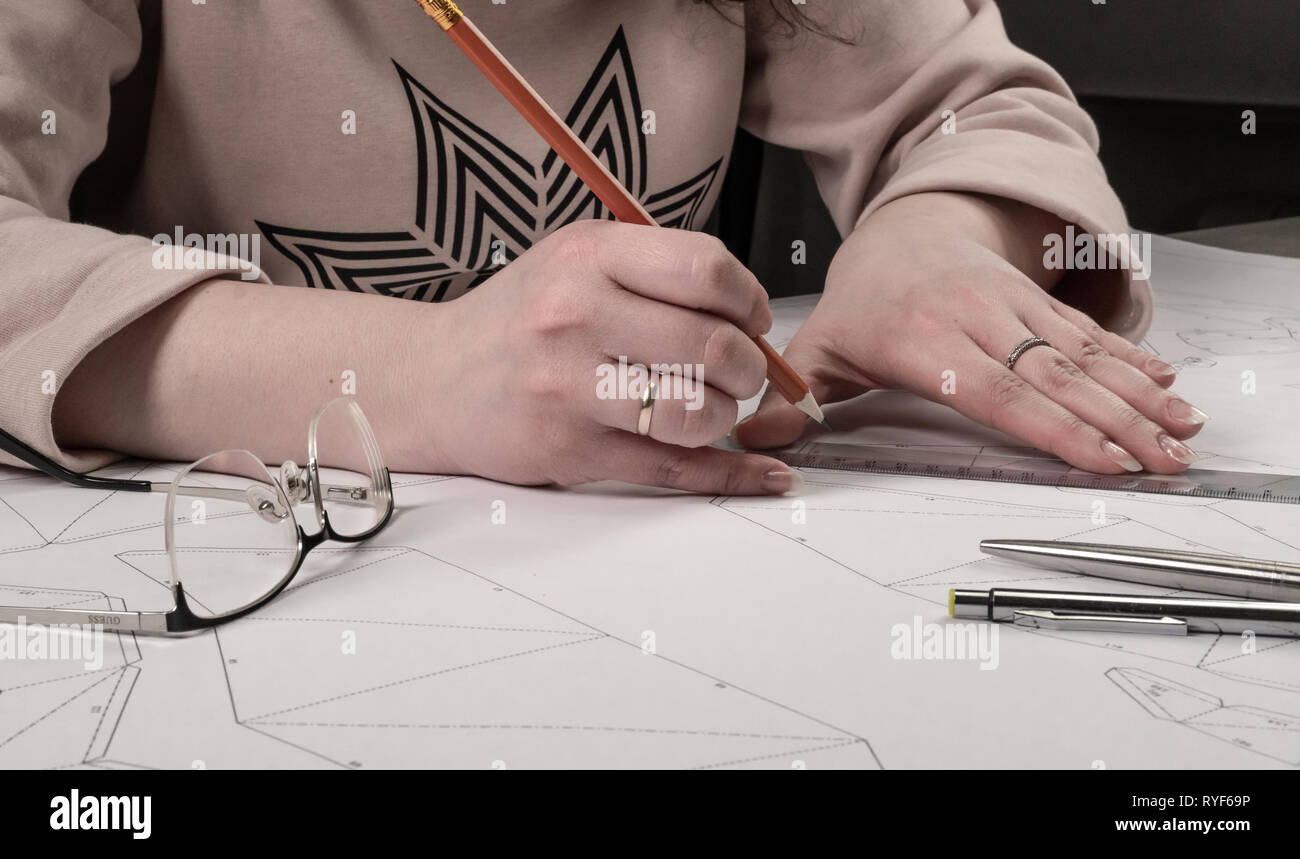 Female designer makes a working drawing. Workplace of a toy designer ...