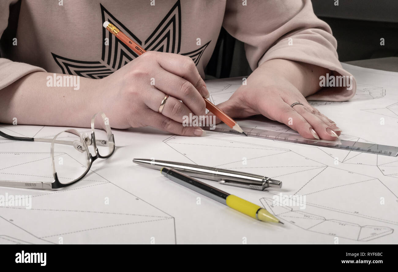 Female designer makes a working drawing. Workplace of a toy designer ...