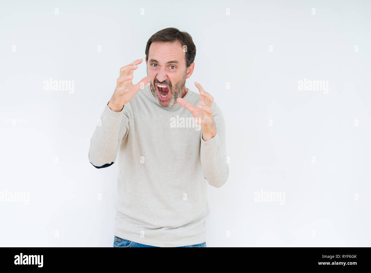 Elegant senior man over isolated background Shouting frustrated with ...