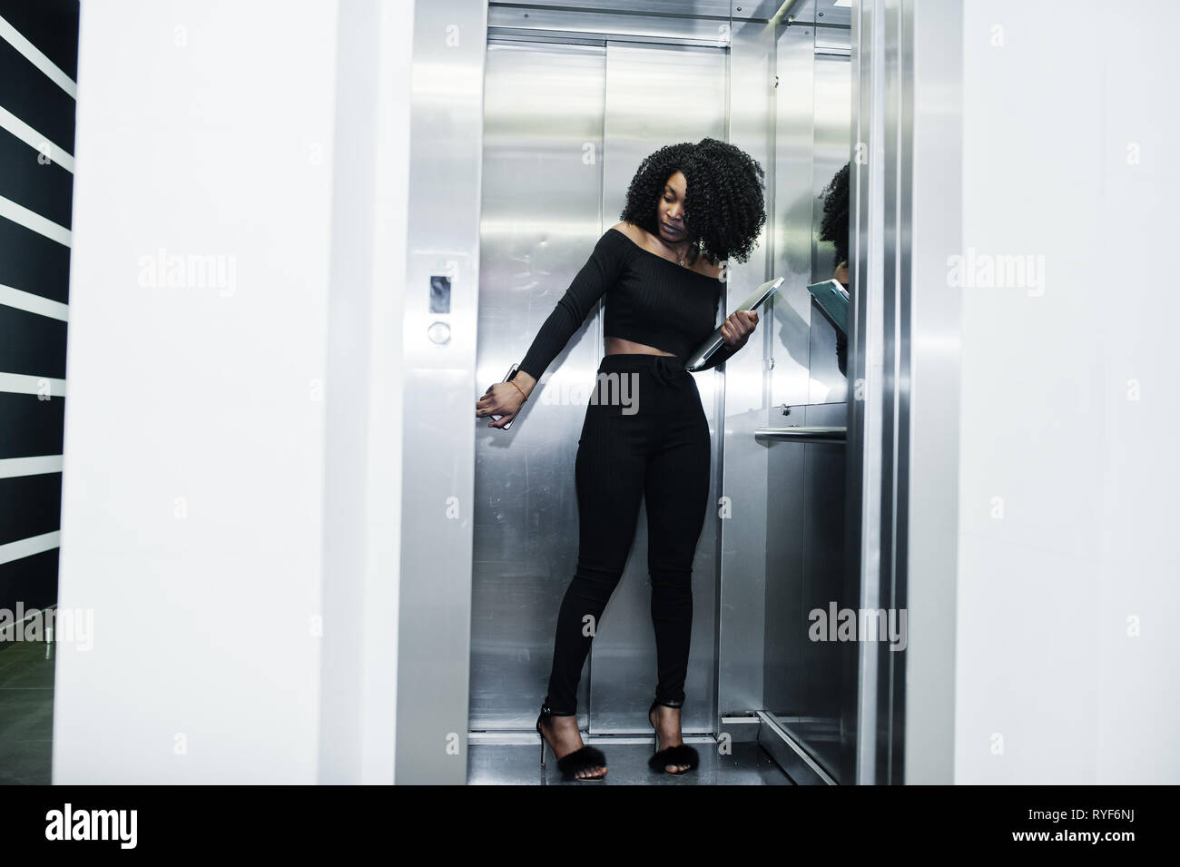 Fashionable young beautiful african american business woman with afro ...