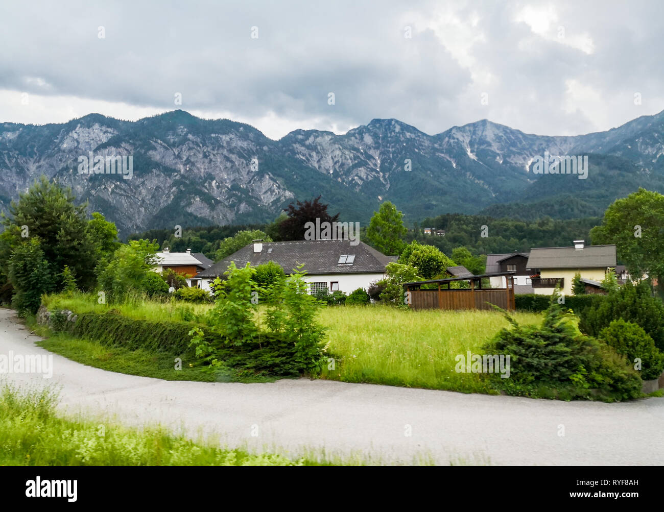 Village in a valley with mountains in the background hi-res stock ...
