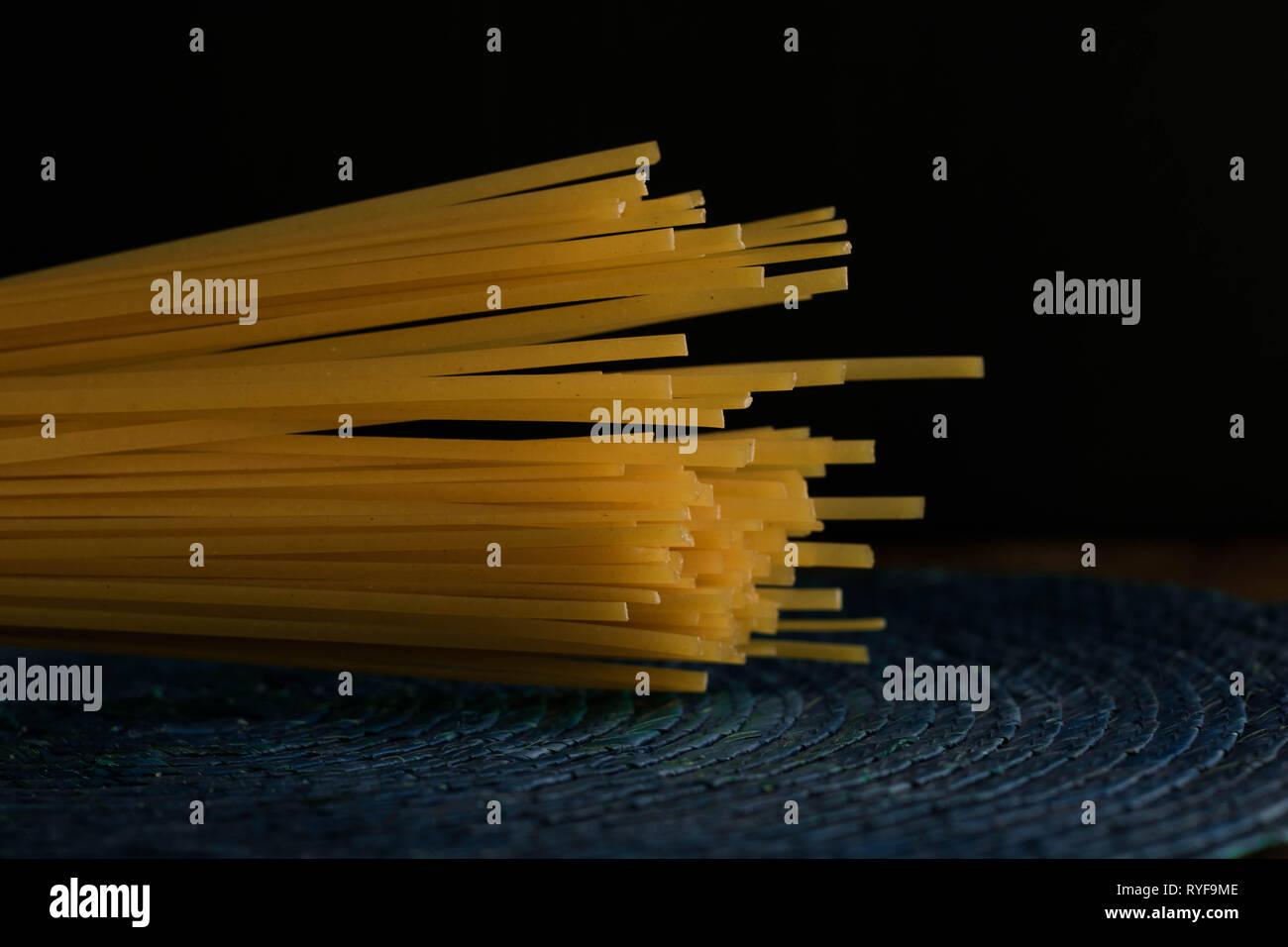 Italian spaghetti raw pasta, dark background black and deep blue Stock ...