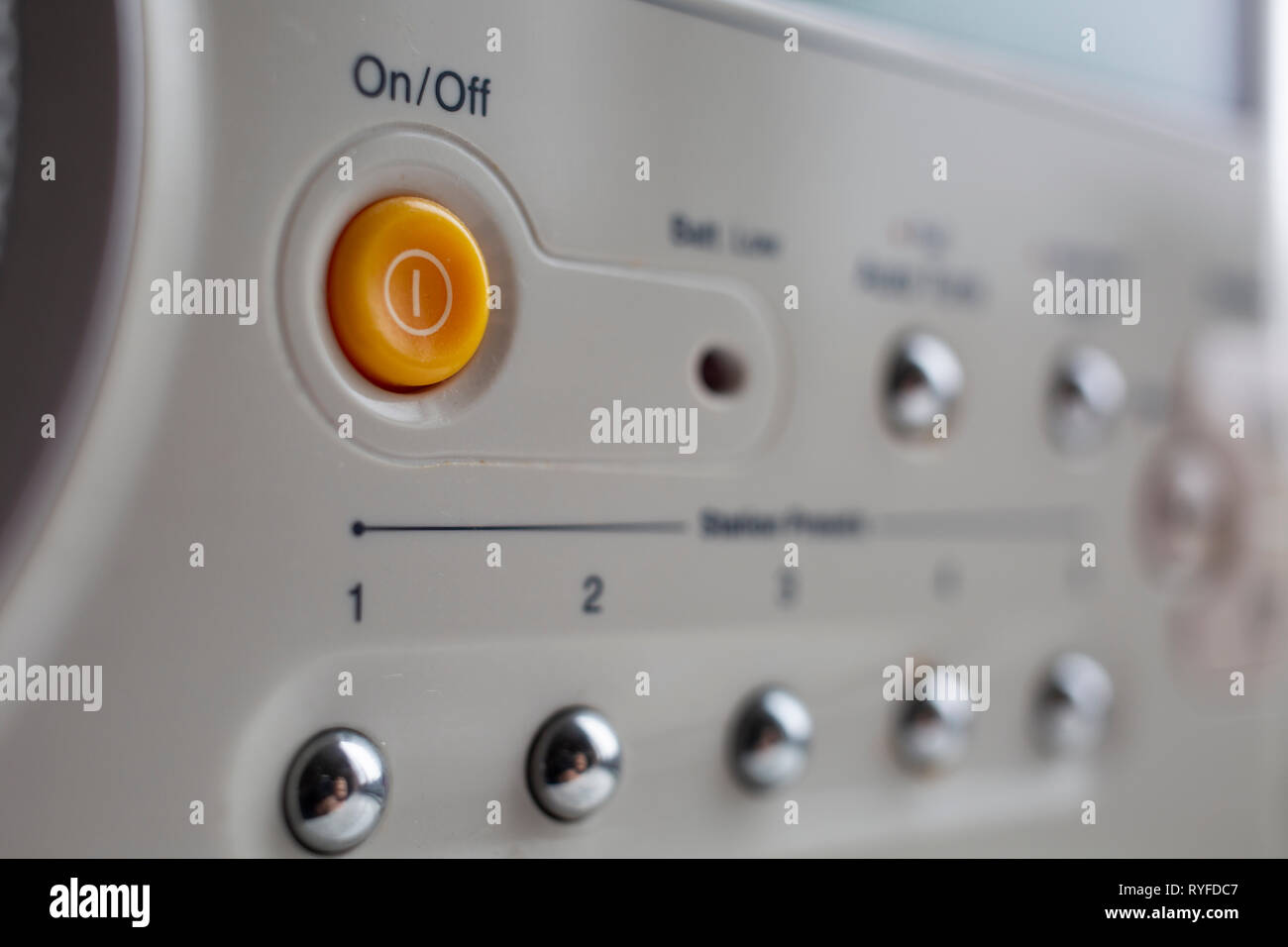 The orange On and Off button on a domestic portable radio Stock Photo ...