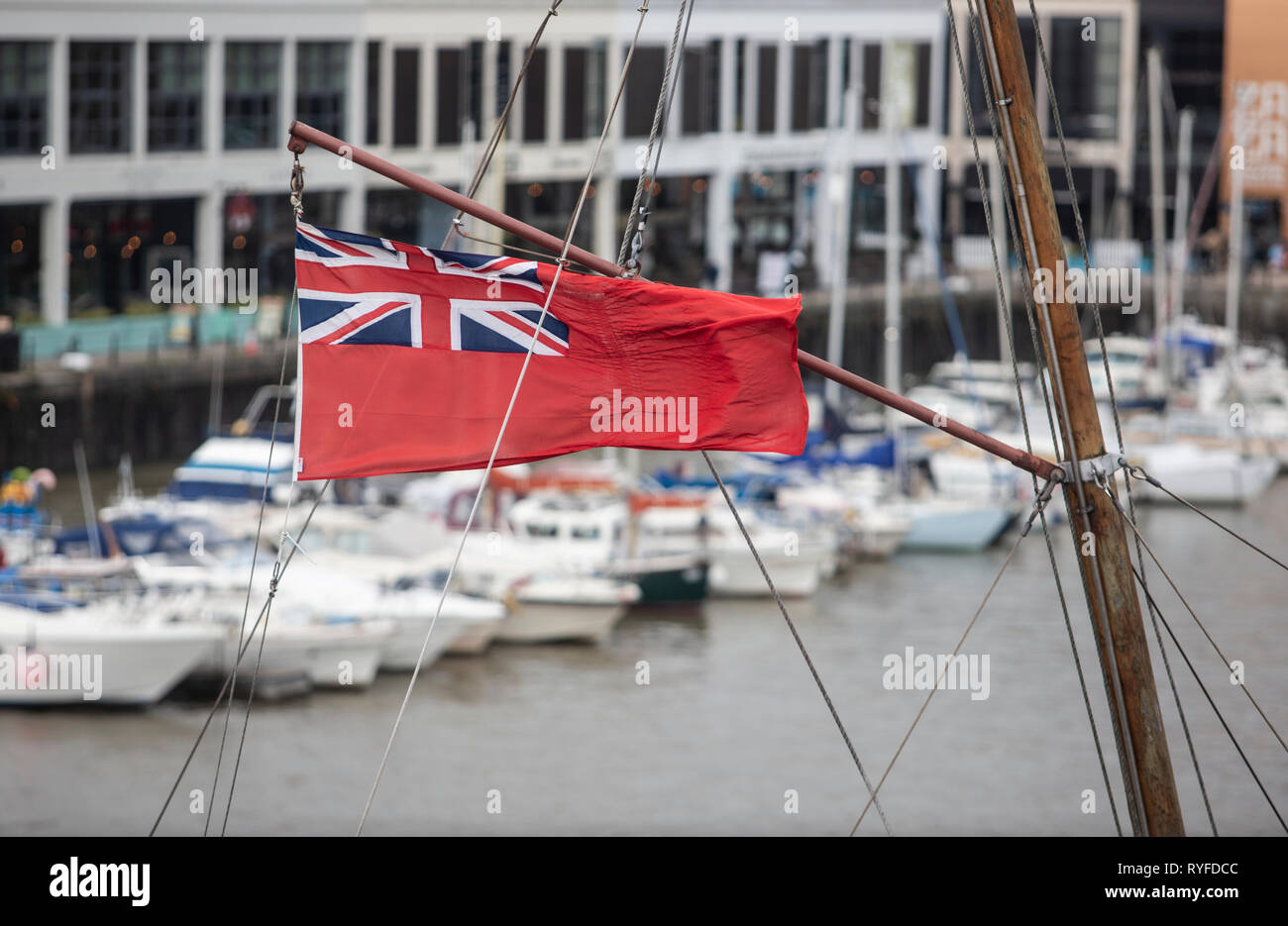 A flag flying in the wind on the mast of a ship moored in the Bristol ...