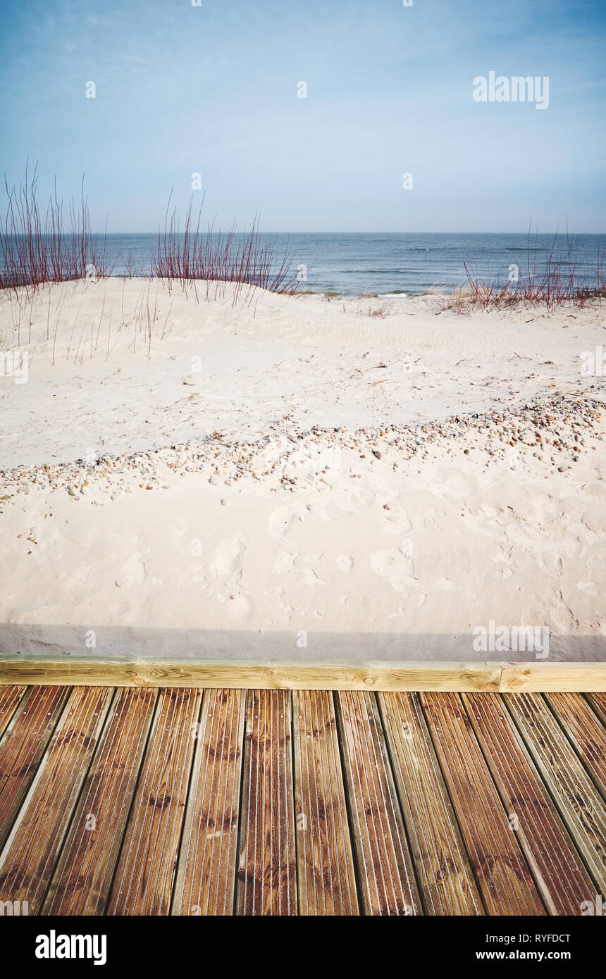 Wooden boardwalk by a beach, color toned picture Stock Photo - Alamy