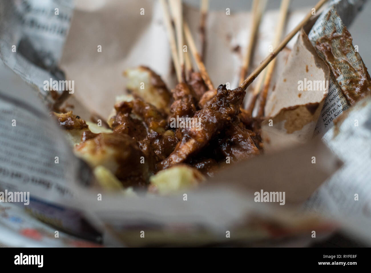 Chicken satay with rice cake (lontong), a street food that you can find ...