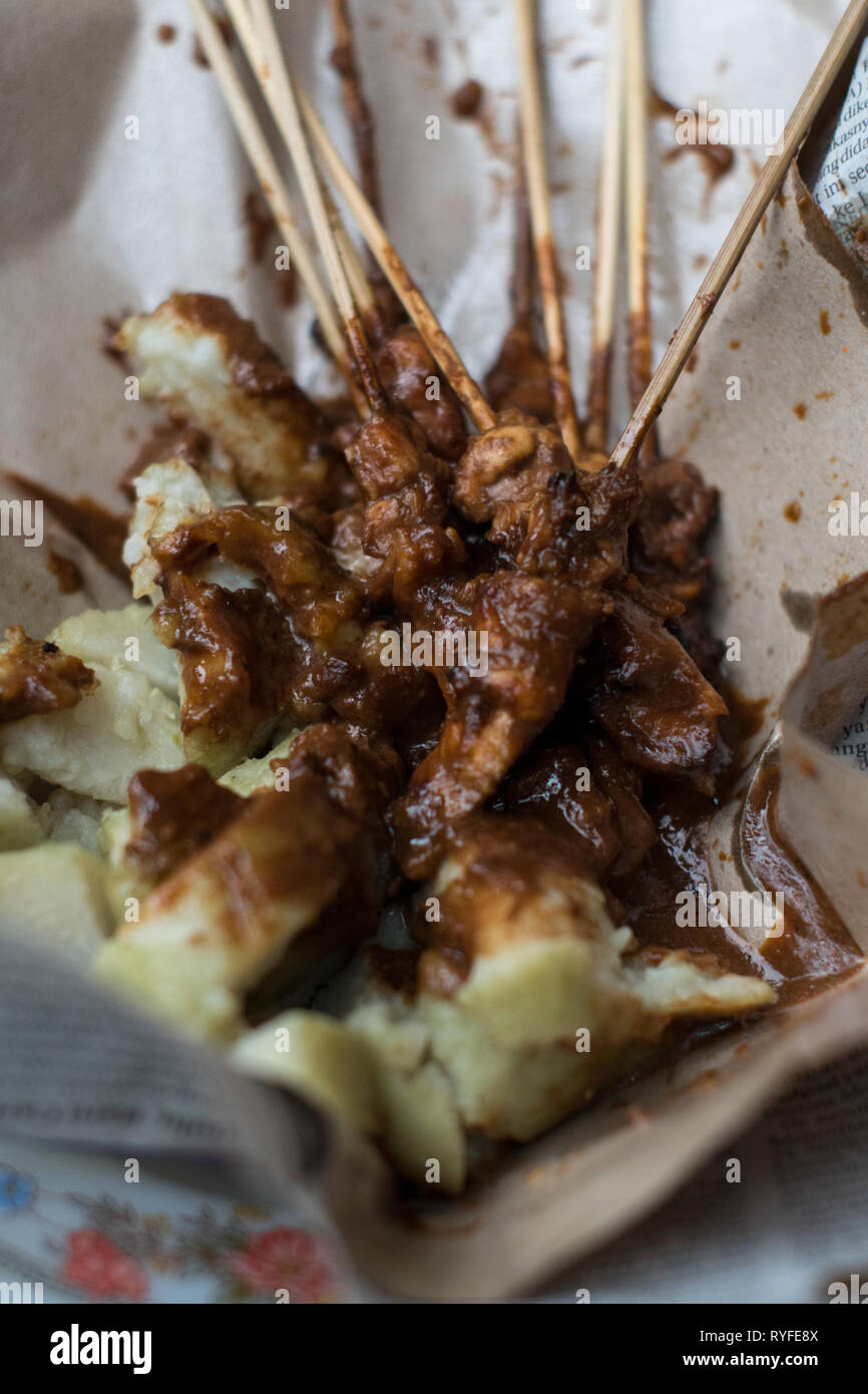 Chicken satay with rice cake (lontong), a street food that you can find ...
