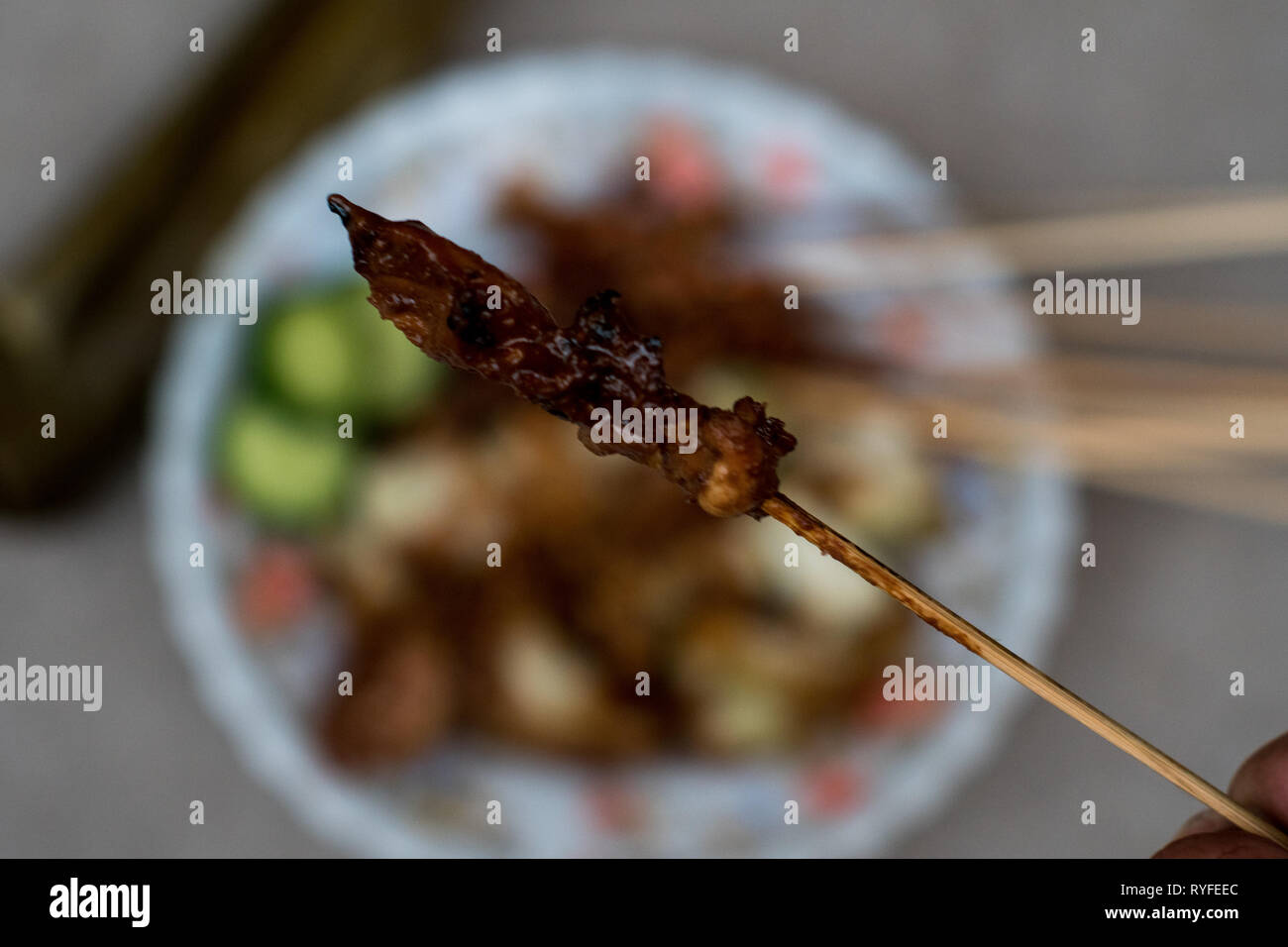 Chicken satay with rice cake (lontong), a street food that you can find ...