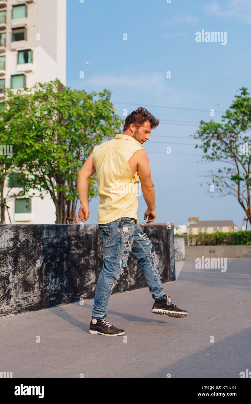 Young handsome man with beard dancing breakdance on the street Stock ...