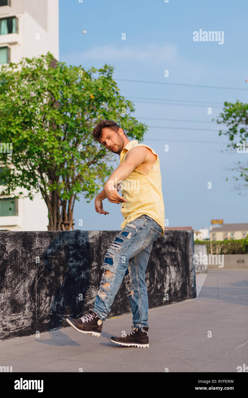 Young handsome man with beard dancing breakdance on the street Stock ...