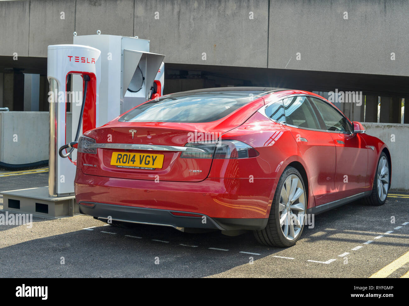 Tesla Model S electric car charging at a Supercharger station Stock ...