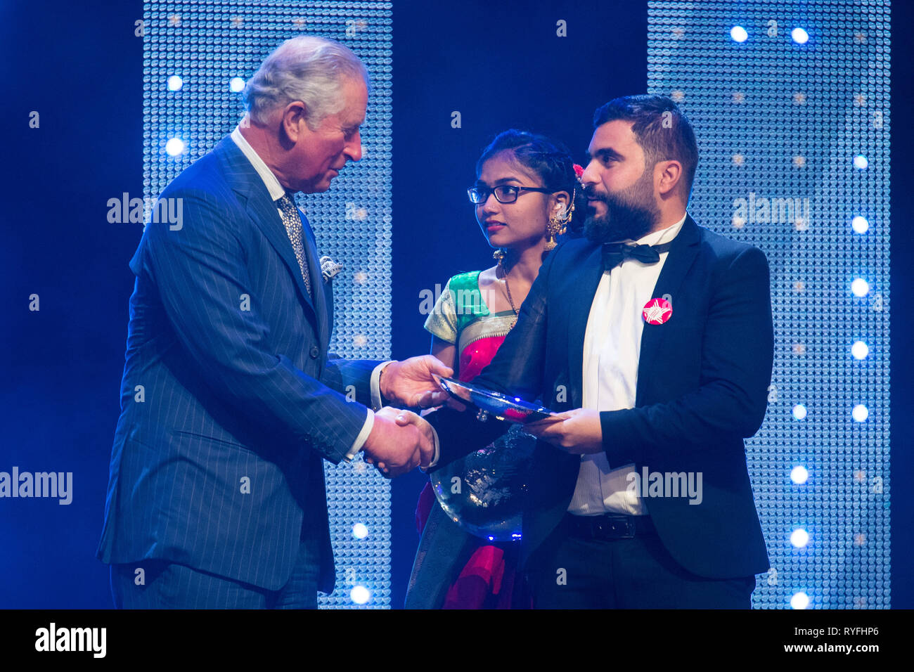 The Prince of Wales with winners of the Global Award Nilam Tambe and Ahmad Abu Rumman onstage at ...