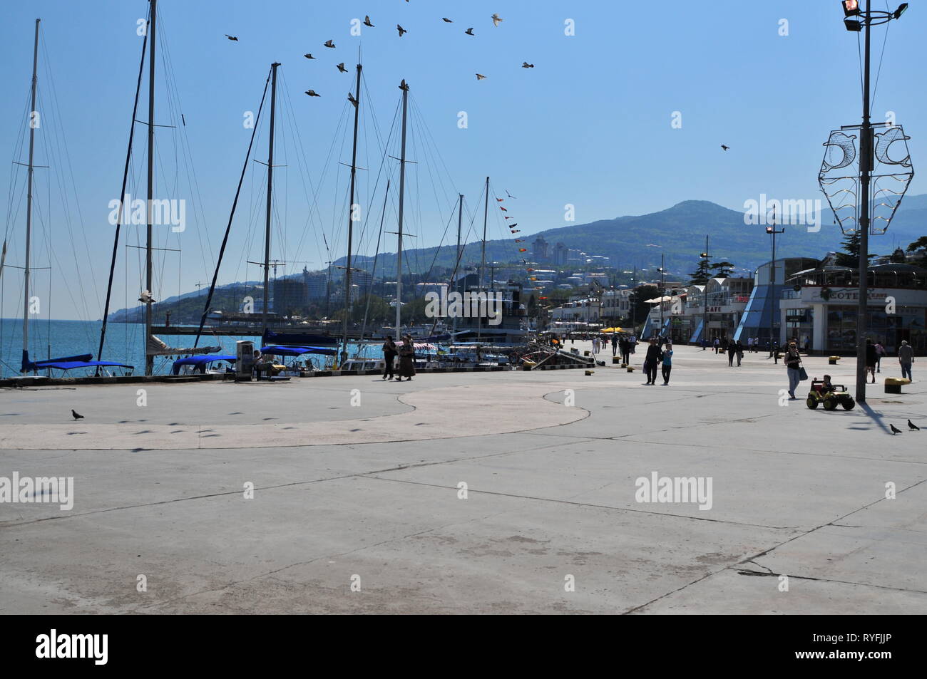 Yalta, Ukraine, May 2011. View on a promenade along seaside with boats ...