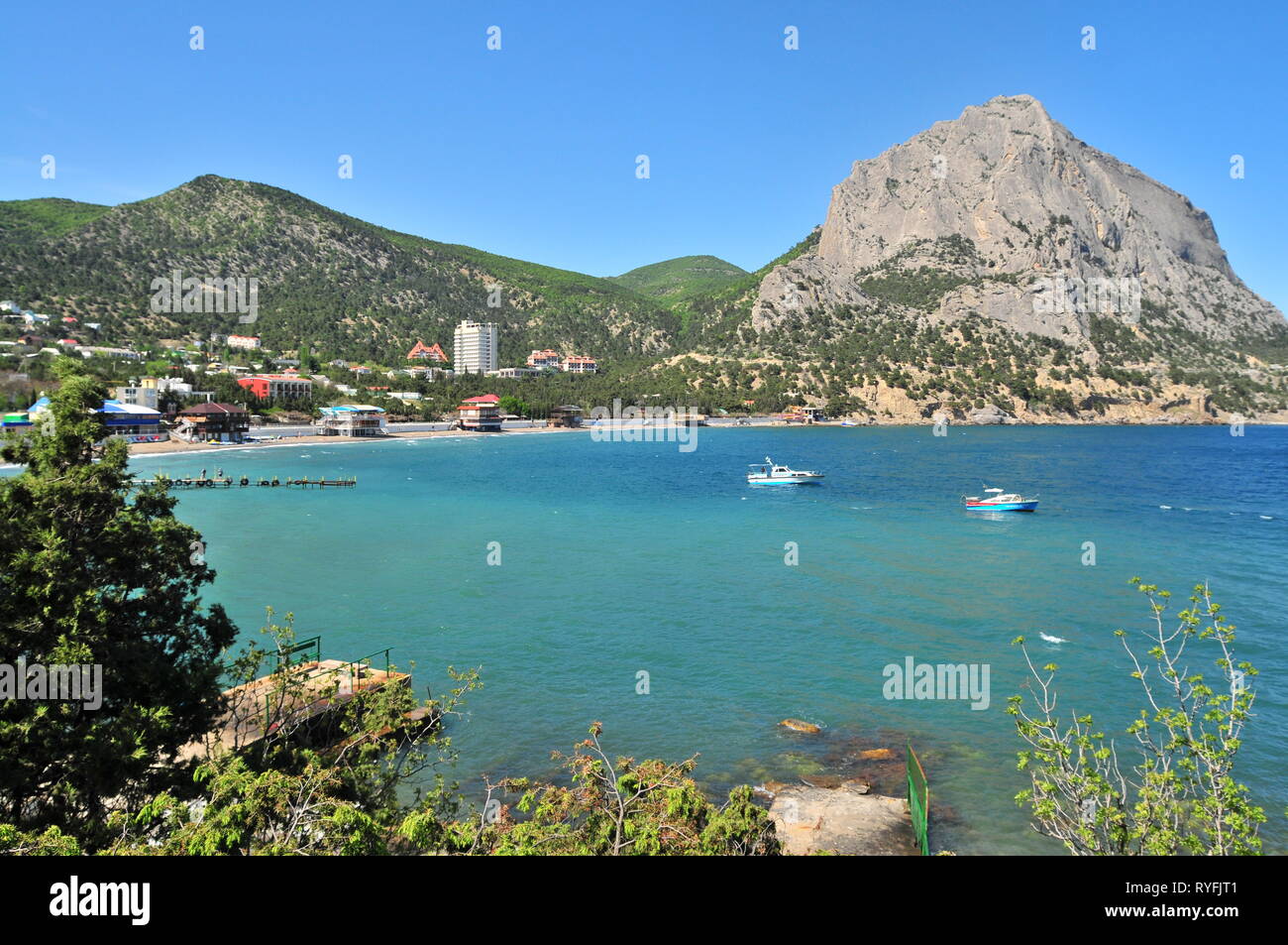 Ukraine, Crimea, Novyi Svit. View of Novyi Svit bay town with giant ...