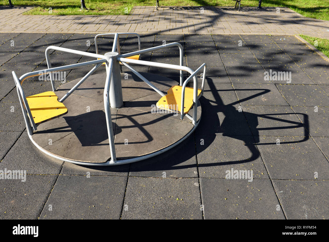 Small carousel on an empty playground in spring - Image Stock Photo - Alamy