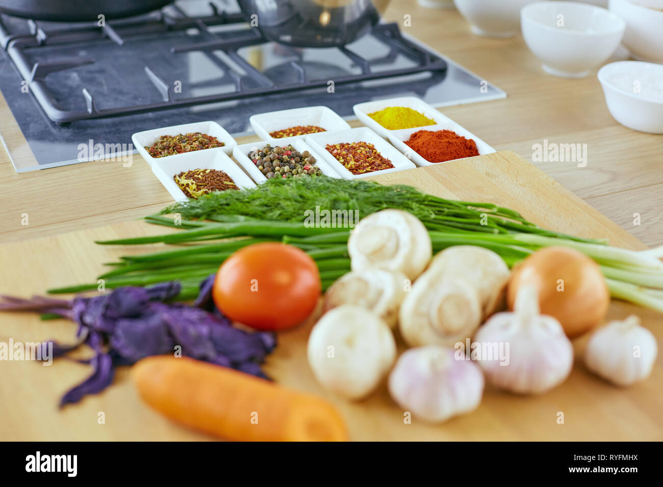 Composition with wooden board and ingredients for cooking on table ...