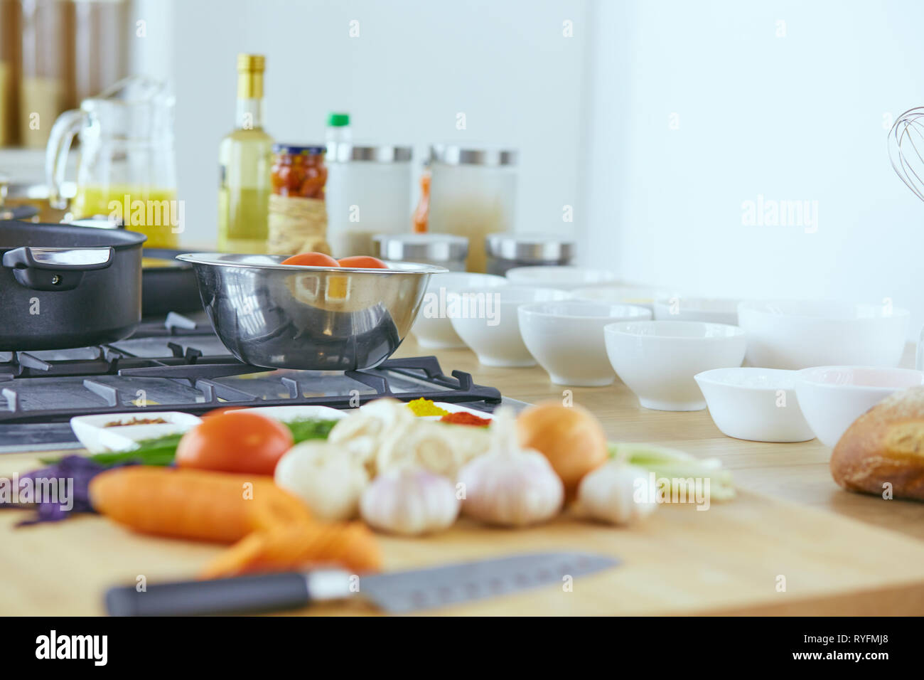 Composition with wooden board and ingredients for cooking on table ...