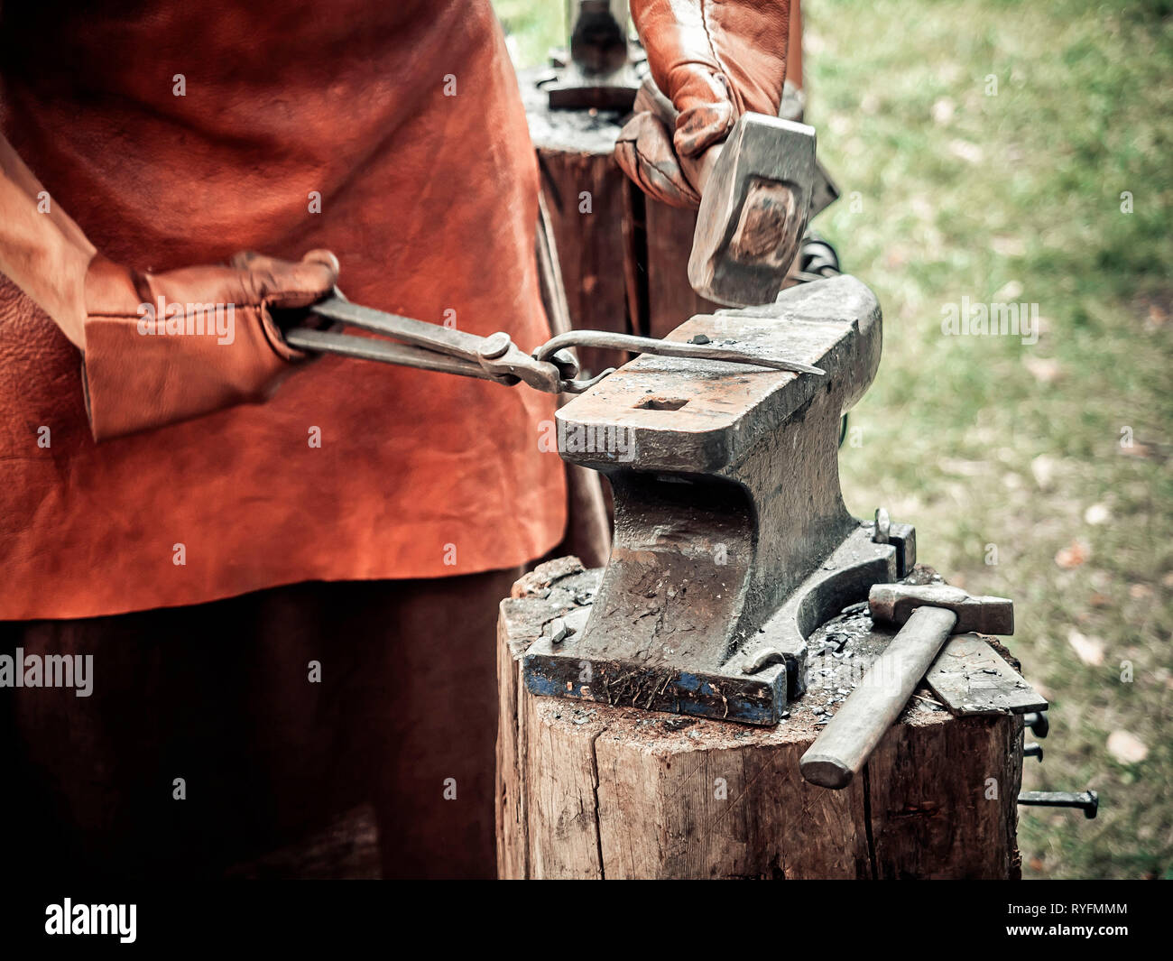 The blacksmith in the production process of metal products handmade on ...