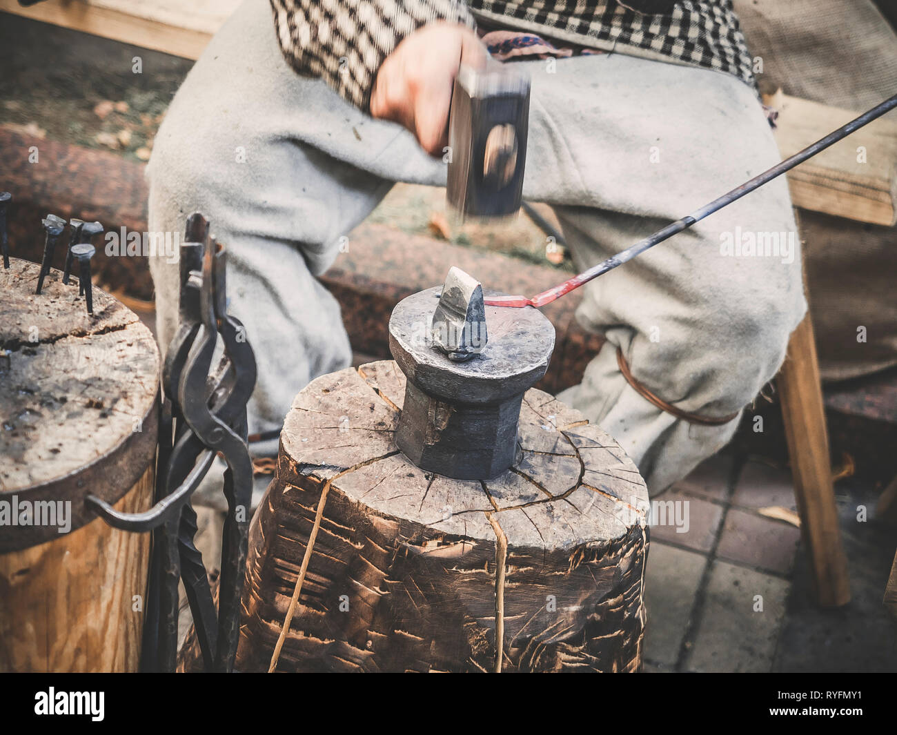 The blacksmith in the production process of metal products handmade on ...