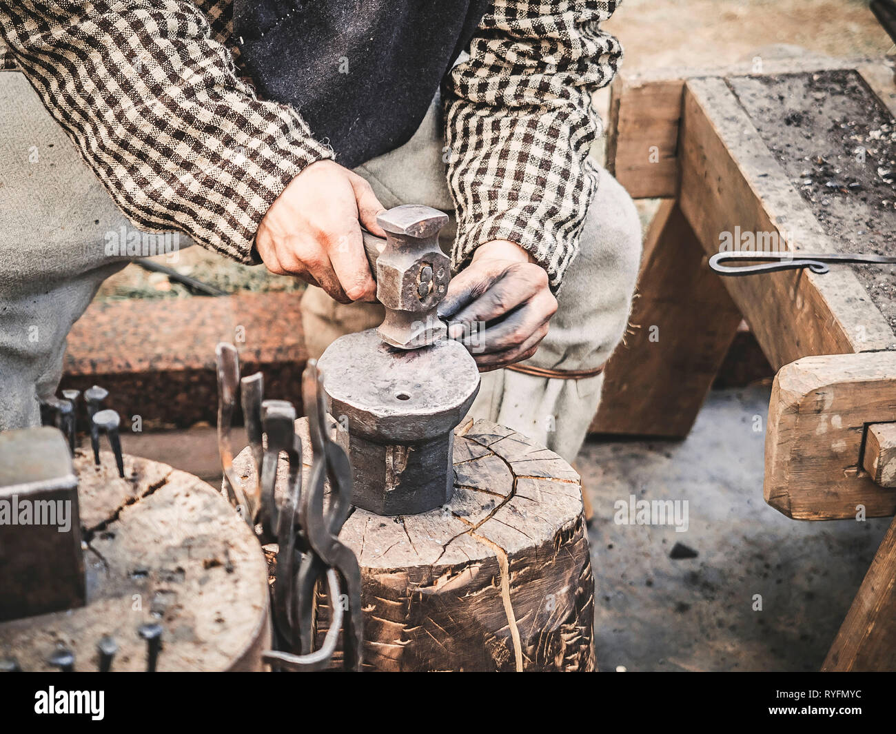 Blacksmith hand with a hammer on steel anvil . Hand of a blacksmith ...