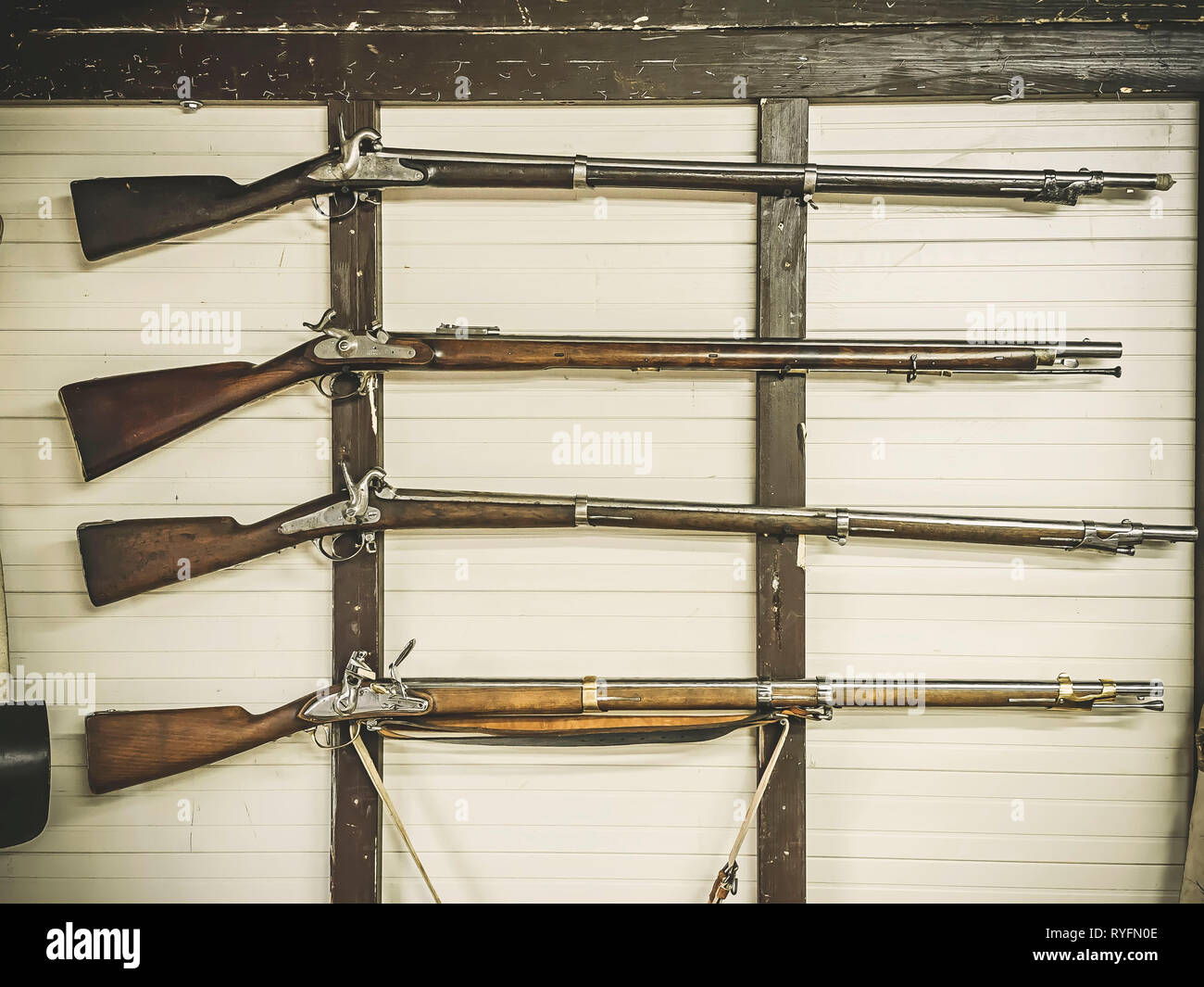 Old service rifles of British military with powder flask hanging on ...