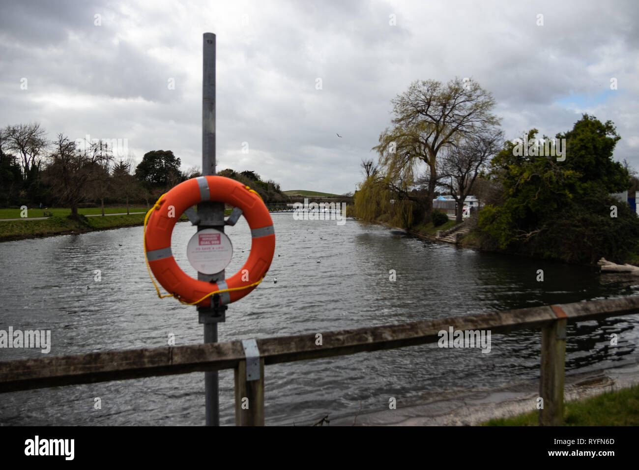 Life ring on a pole at the lake Stock Photo - Alamy