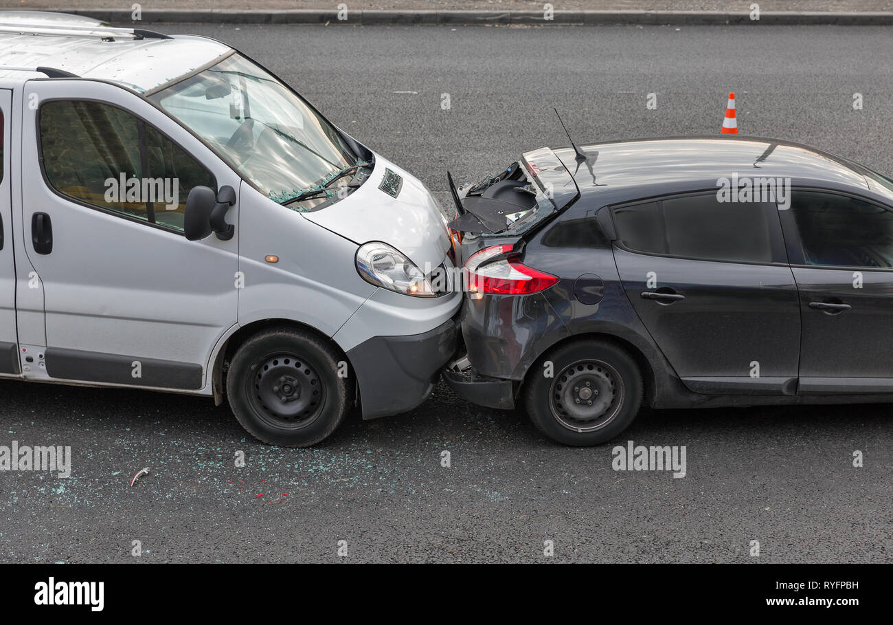 Auto accident involving two cars on a city street Stock Photo - Alamy