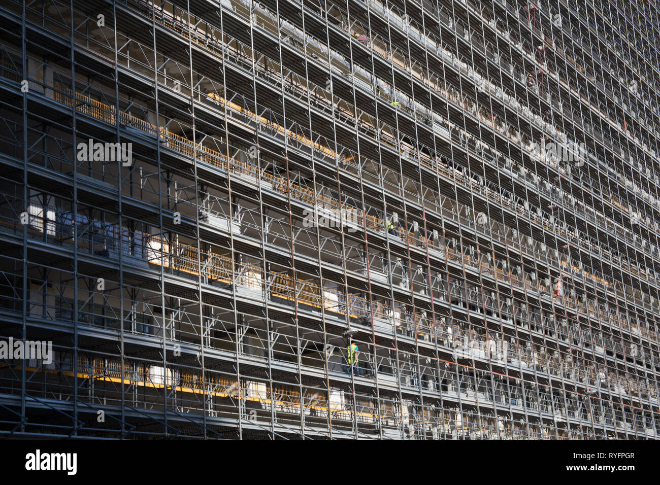 The abstract grid of scaffolding on a building under construction in ...