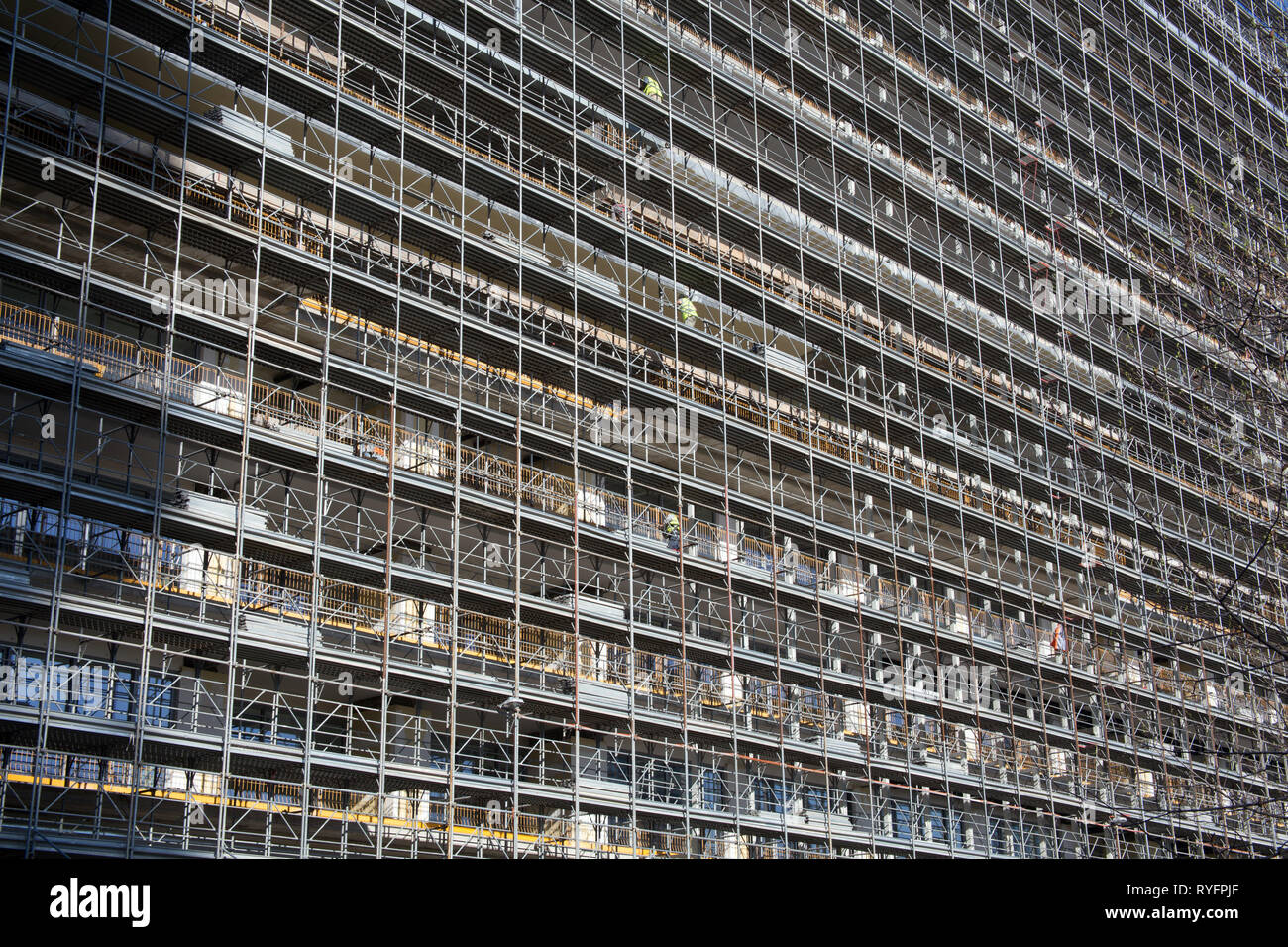 The abstract grid of scaffolding on a building under construction in ...