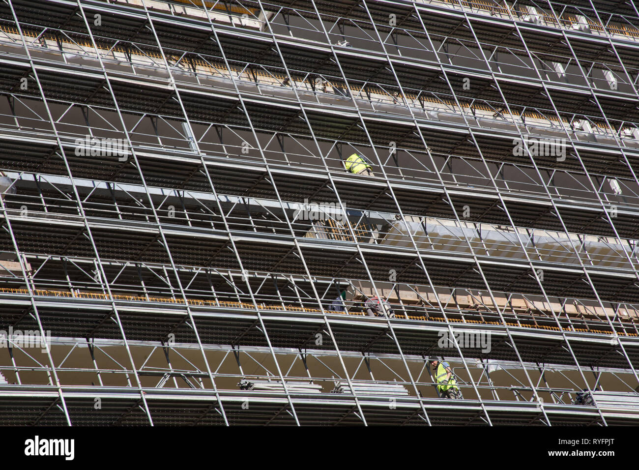 The abstract grid of scaffolding on a building under construction in ...