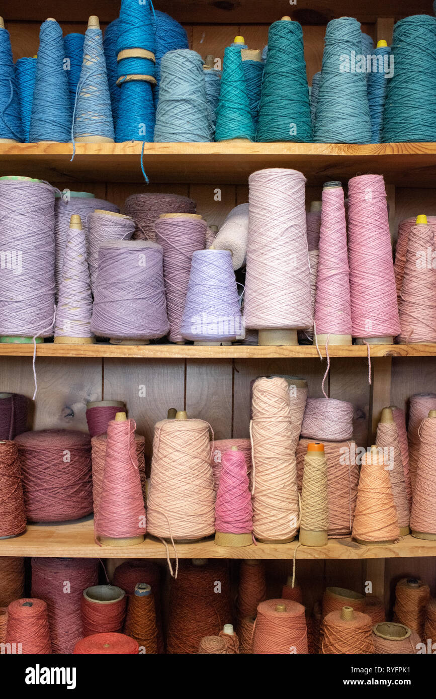 A wall of colorful yarn is lined up, ready for the artist's new ...