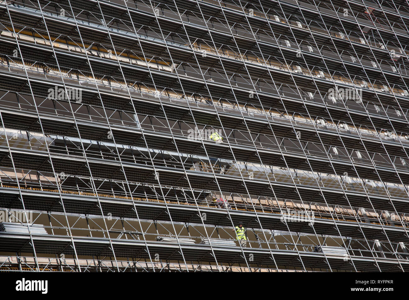 The abstract grid of scaffolding on a building under construction in ...
